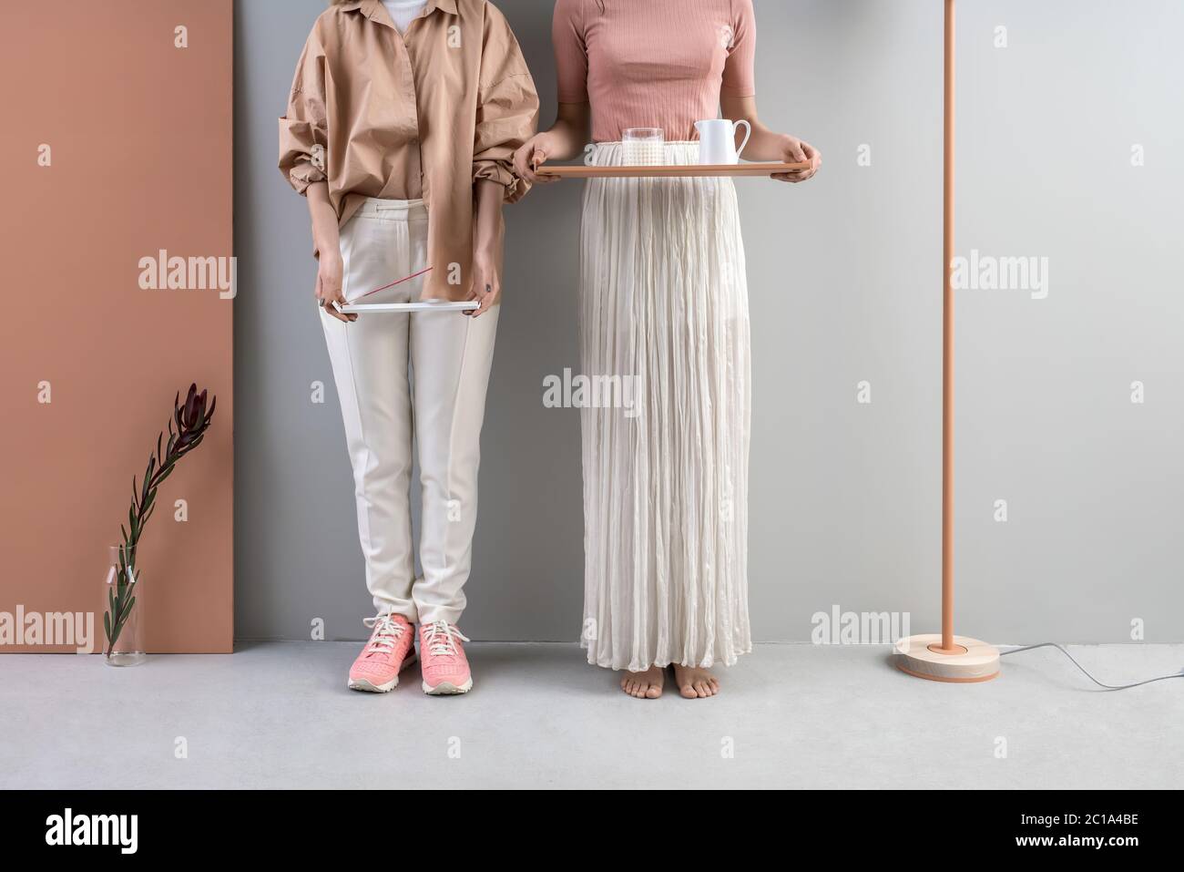 Girls holding tray and support Stock Photo - Alamy