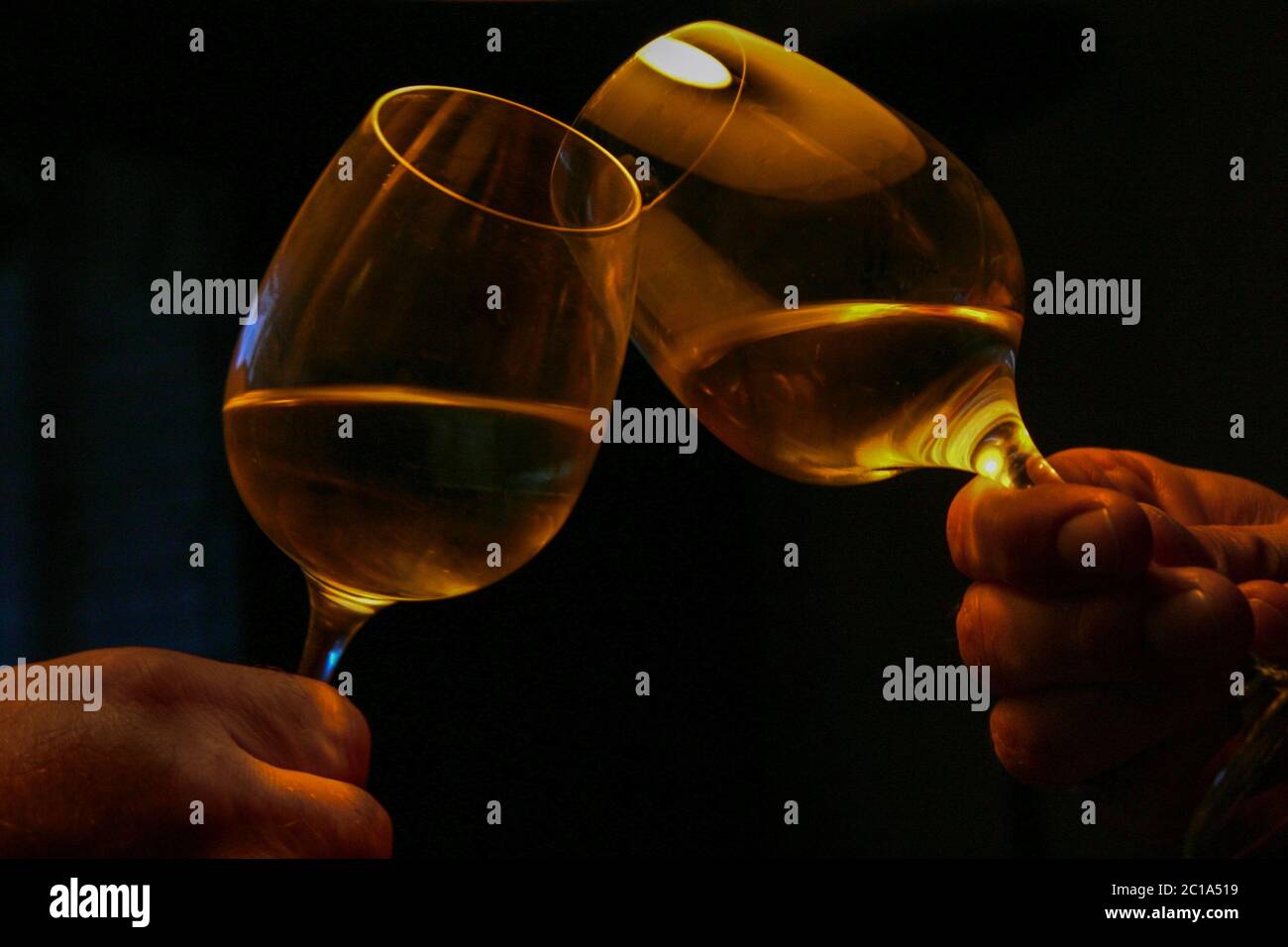 Two glasses toasting with dark background. Special atmosphere Stock ...
