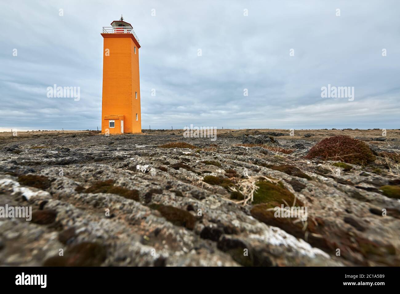 Icelandic landscape with orange lighthouse Stock Photo - Alamy