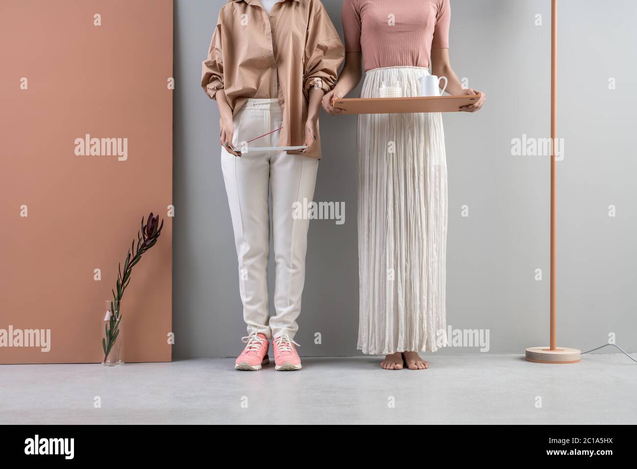 Girls holding tray and support Stock Photo - Alamy
