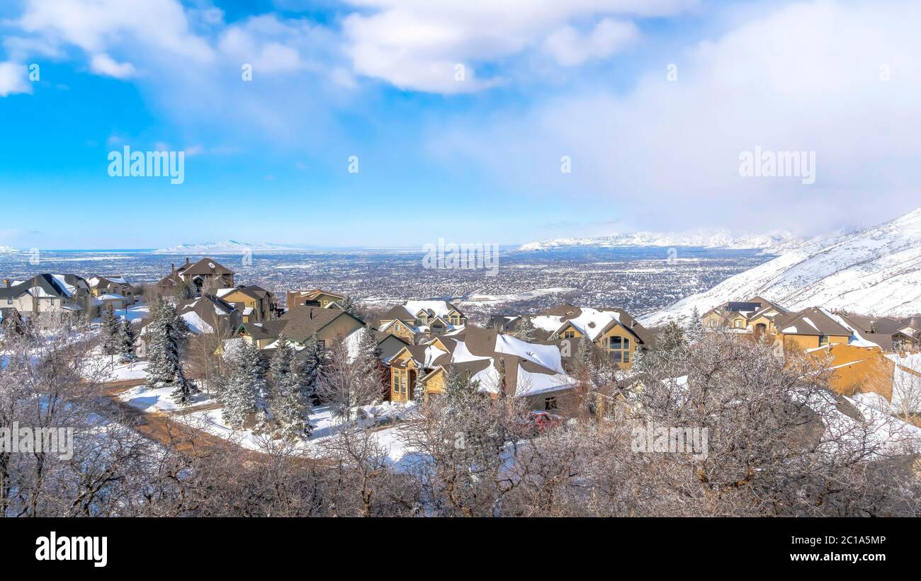 Panorama Wasatch Mountains in winter with homes on a neighborhood amid ...
