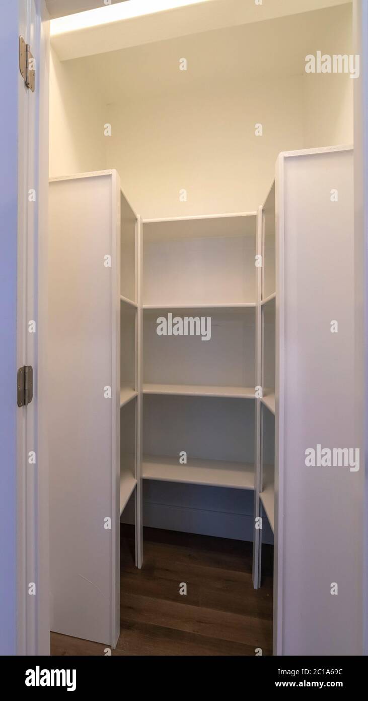 Vertical Looking into empty interior of a walk-in closet Stock Photo ...