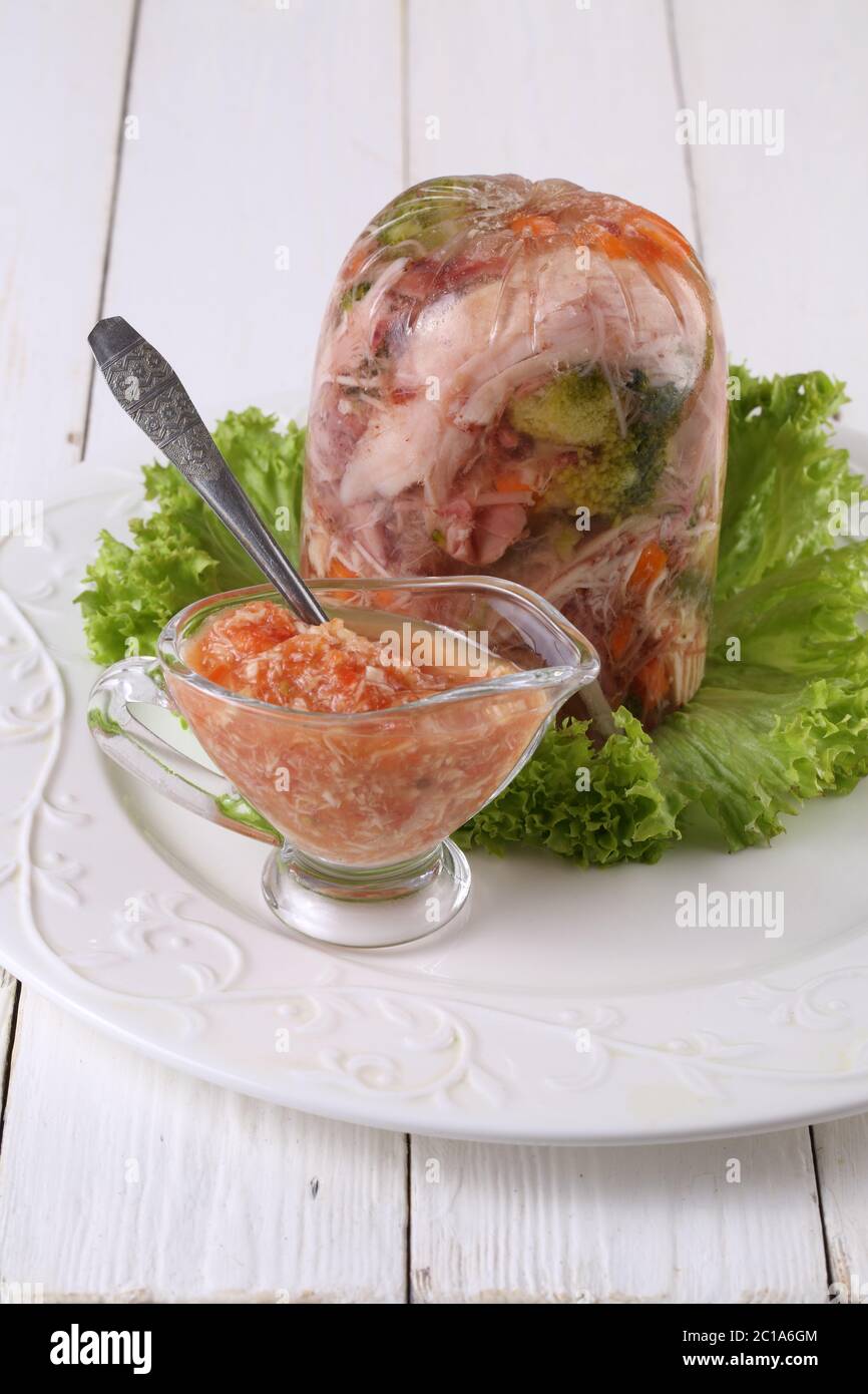 Jelly with meat. traditional Russian dish. Meat aspic with horseradish ...