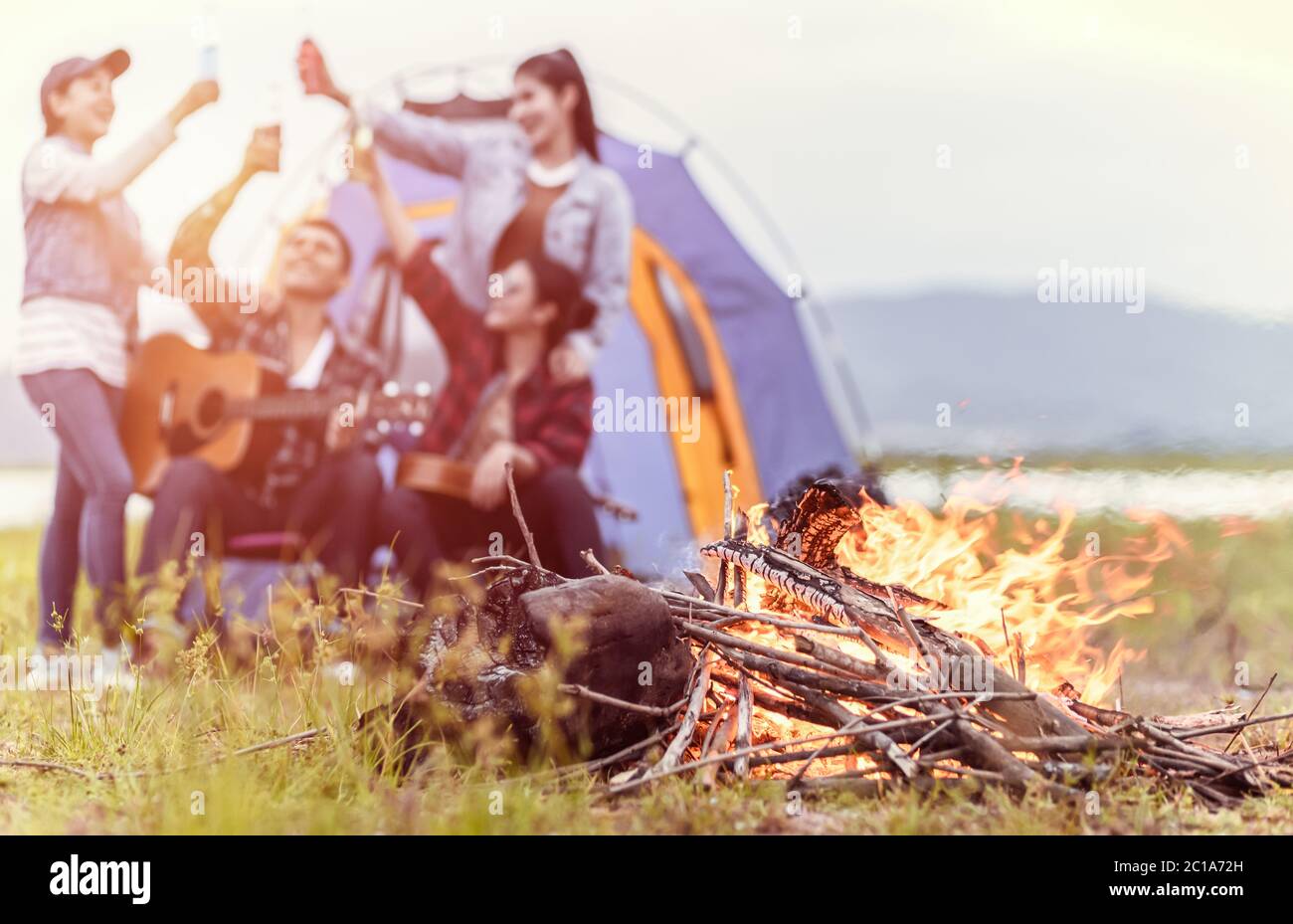 Group of Friends having fun together and drinking at camping near the ...