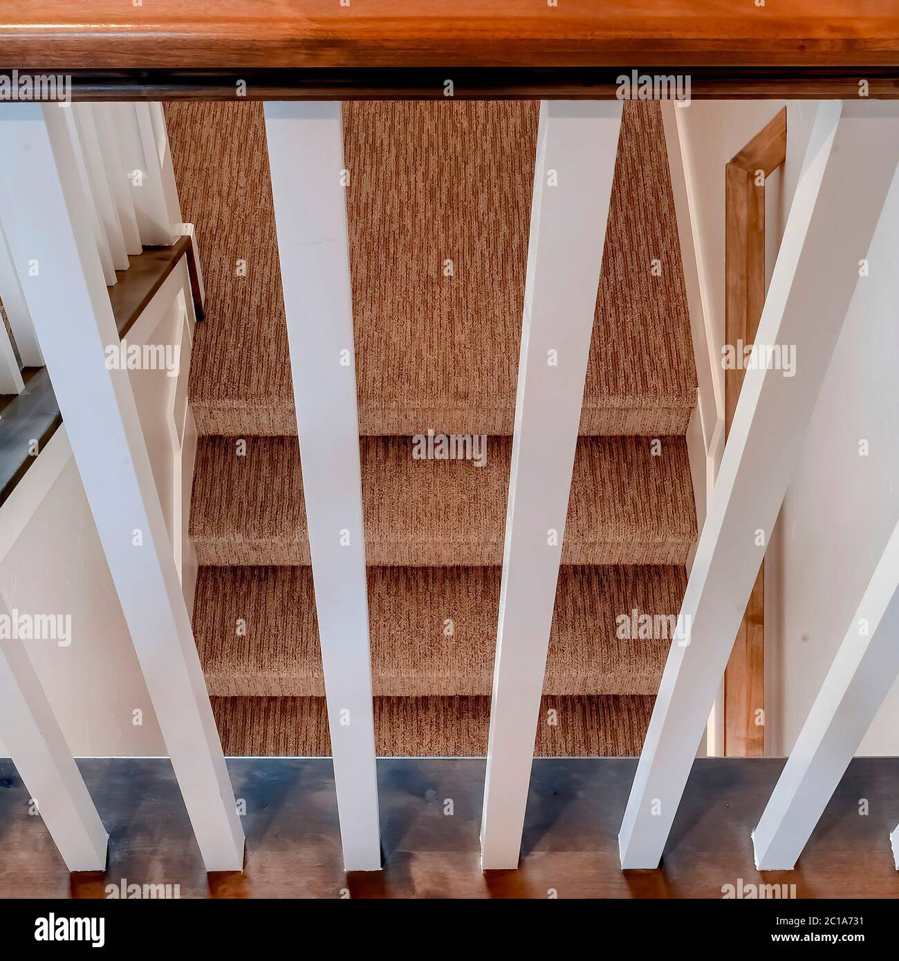 Square frame U shaped staircase with white baluster brown handrail and ...