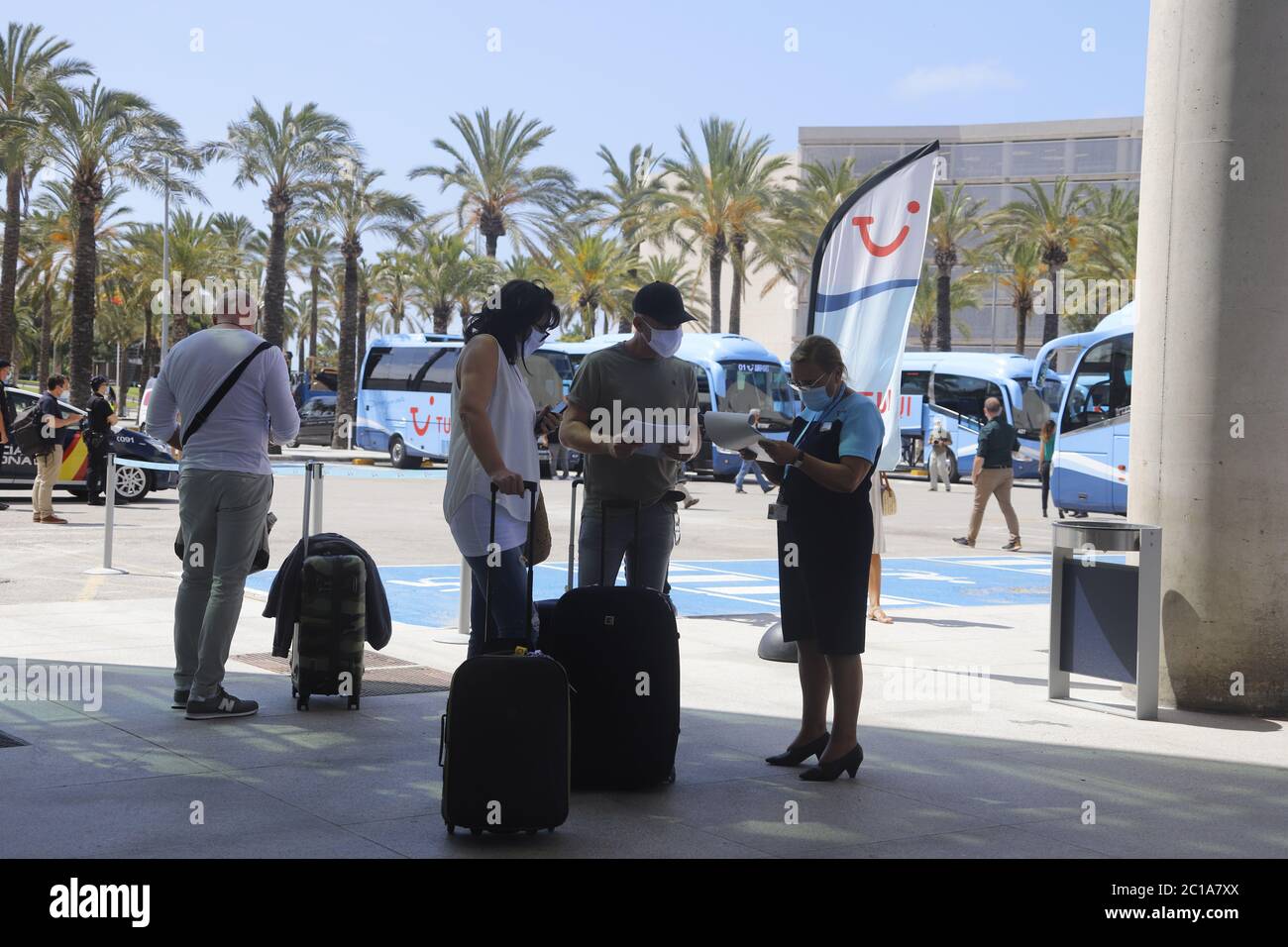 Palma, Spain. 15th June, 2020. A TUI employee offers assistance to two ...