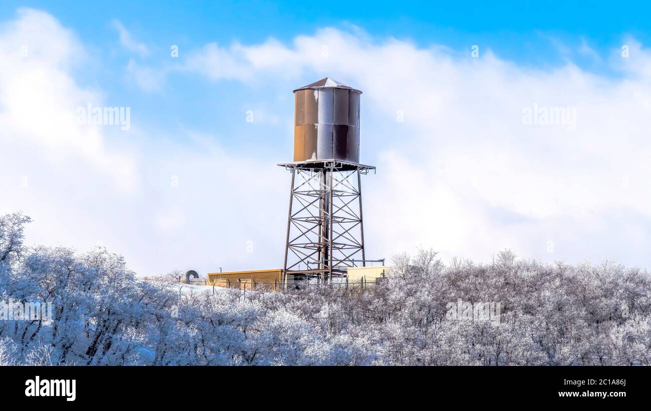 Panorama Water tank storage container on a tower at the snowy slope of ...