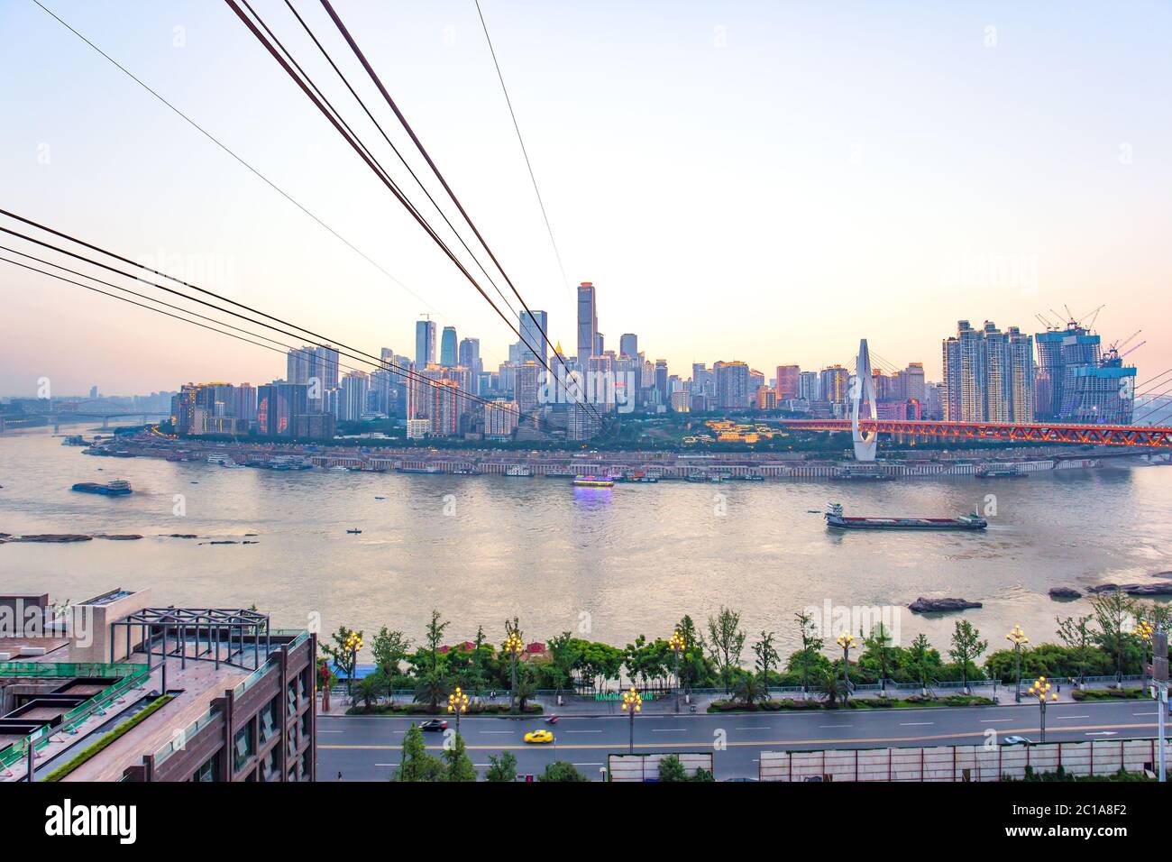 steel cable over river and modern cityscape Stock Photo - Alamy
