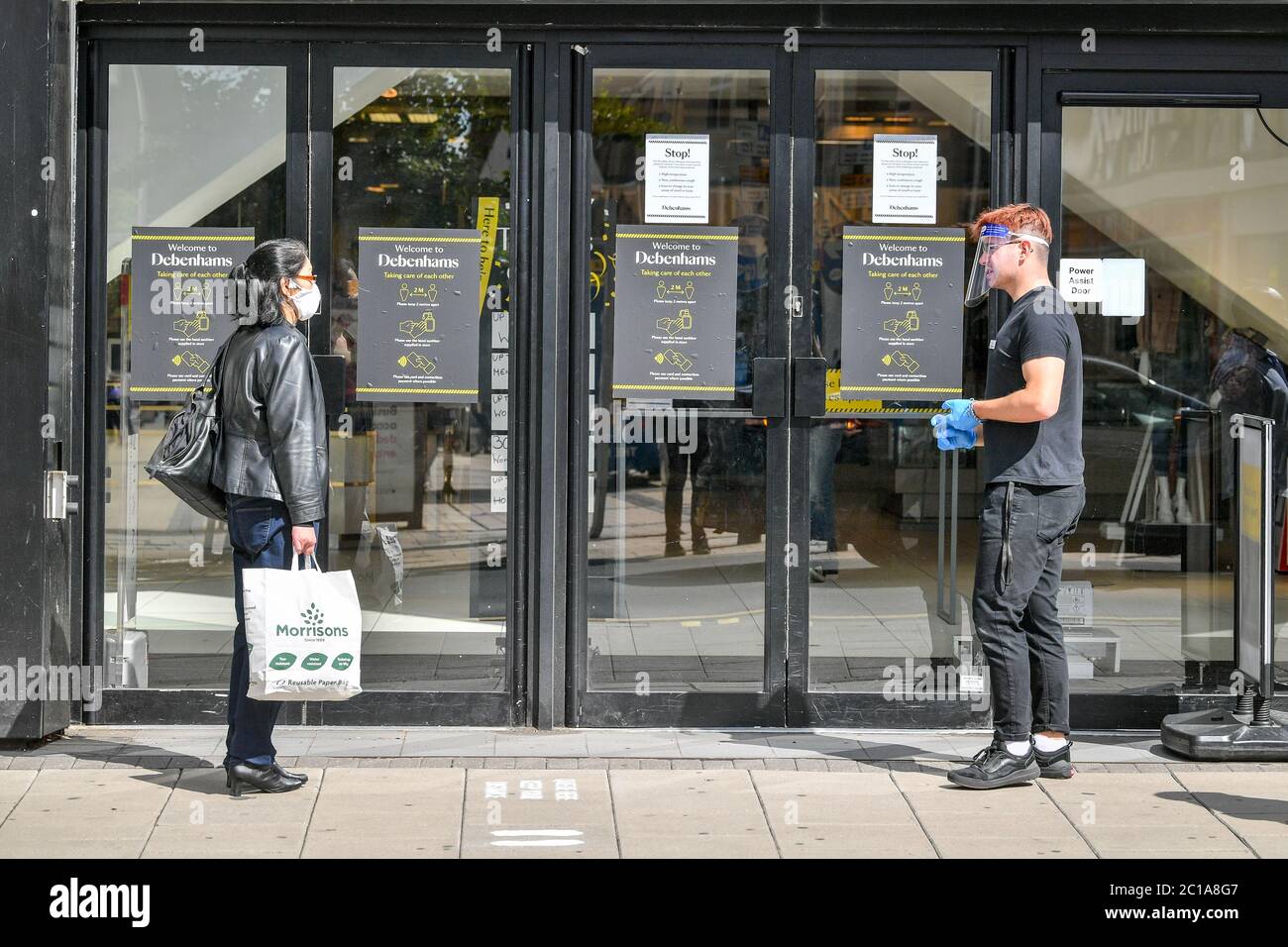 A shop assistant wears ppe in Bristol as non-essential shops in England ...