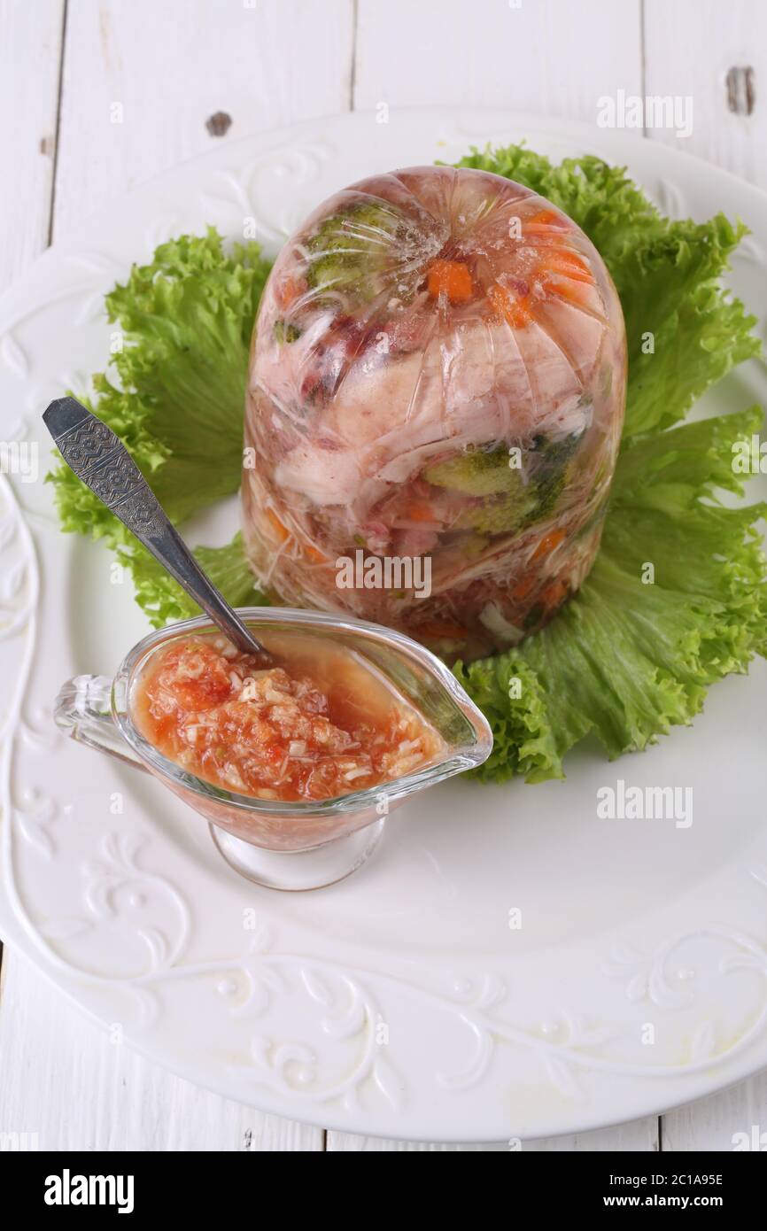Jelly with meat. traditional Russian dish. Meat aspic with horseradish ...