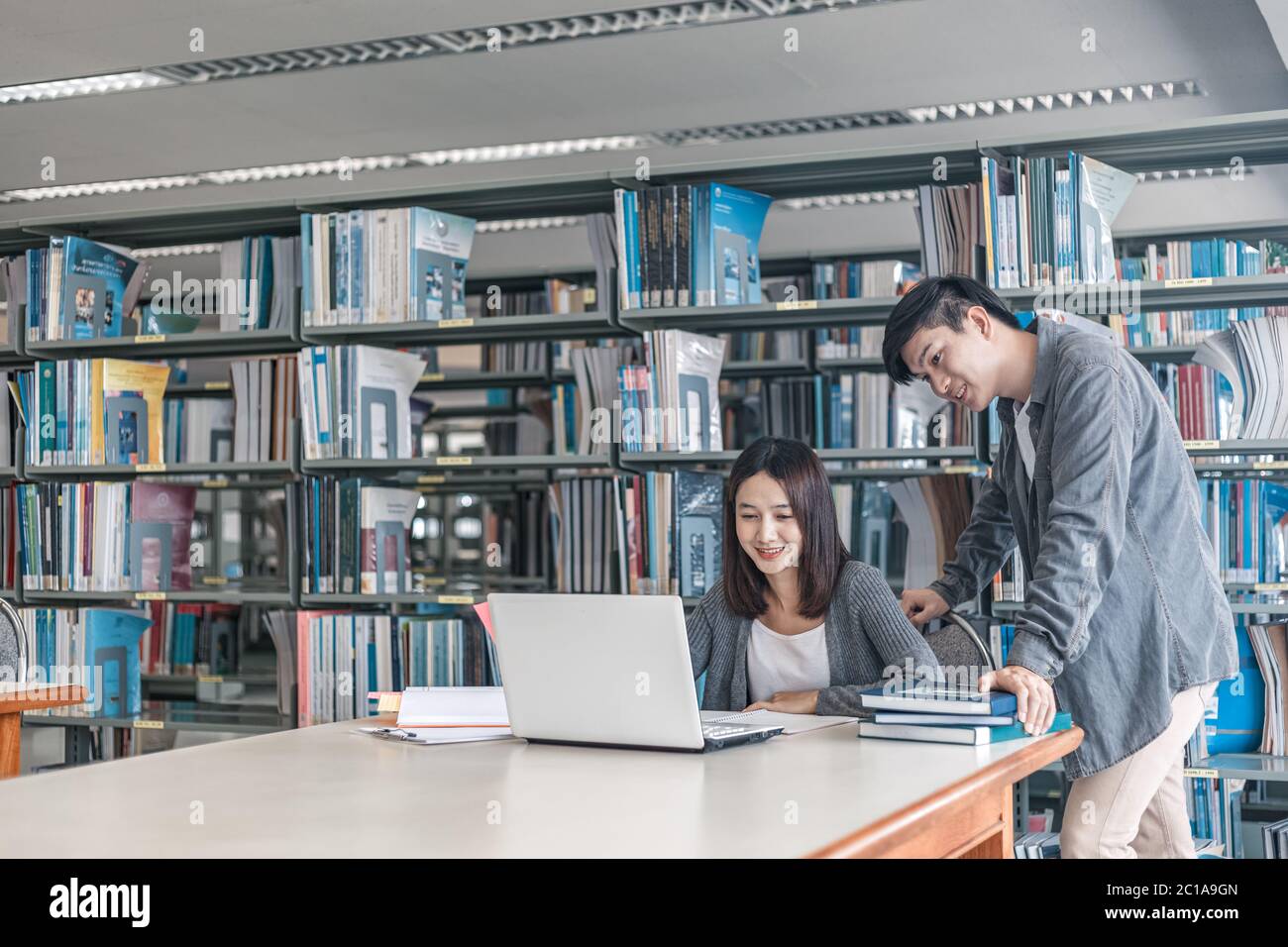 High school or college students studying and reading together in ...