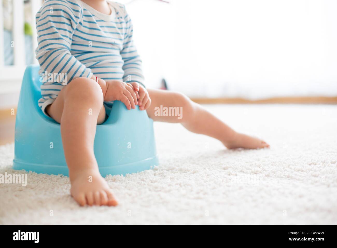 Cute toddler boy, potty training, playing with his teddy bear on potty ...