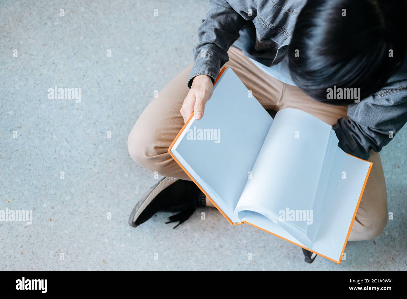 Student college opening and reading a book at library Stock Photo - Alamy