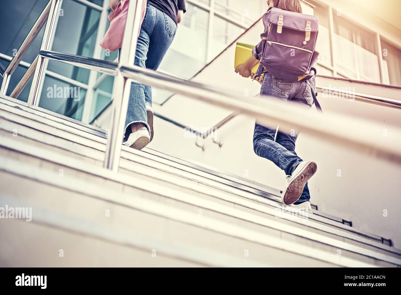 college student walking up the staircase Stock Photo - Alamy