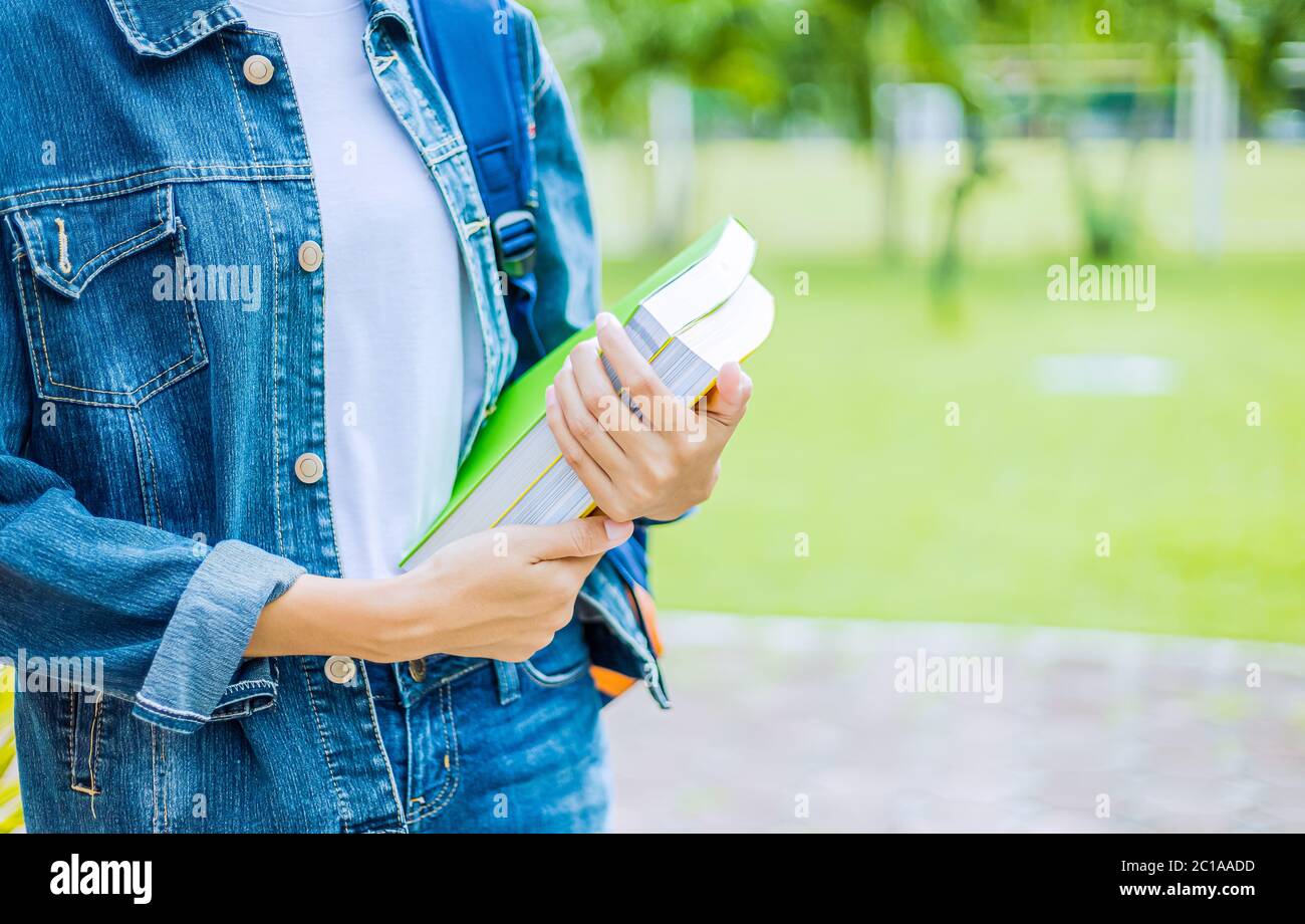 Student hold book after finish study at university Stock Photo - Alamy