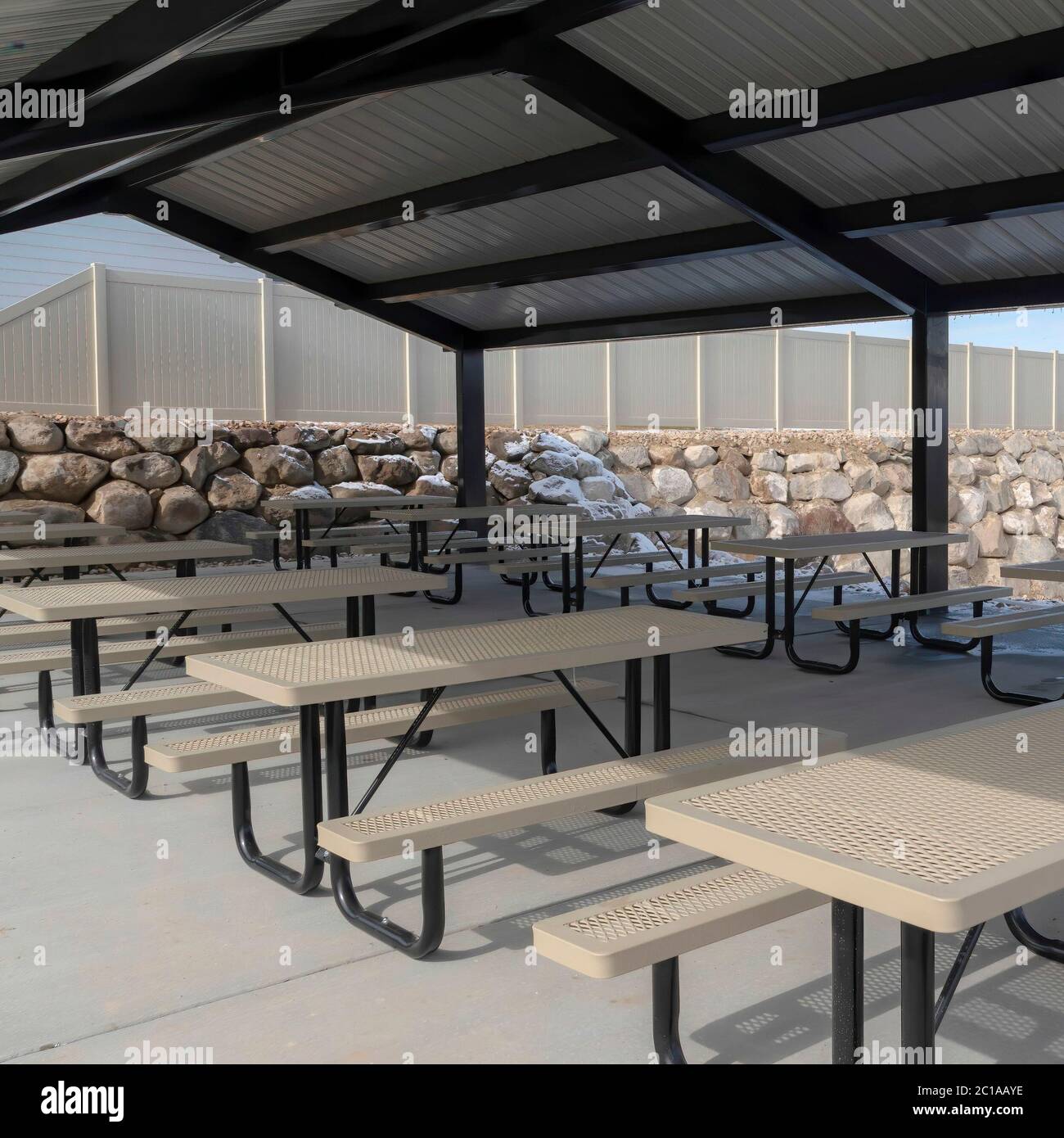 Square Tables with seats inside a gabled roof pavilion in South Jordan ...