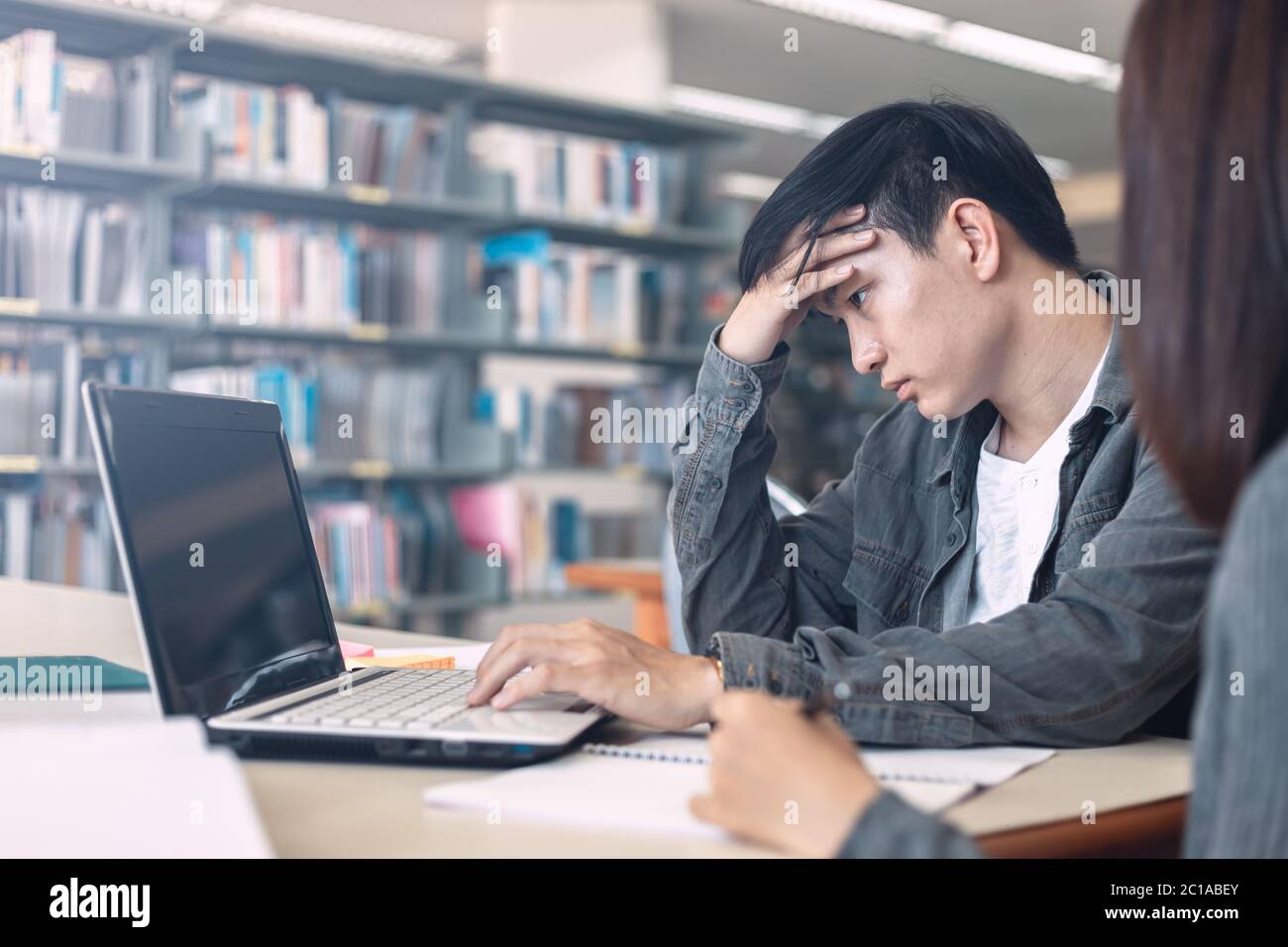 High school or college students studying and reading together in ...