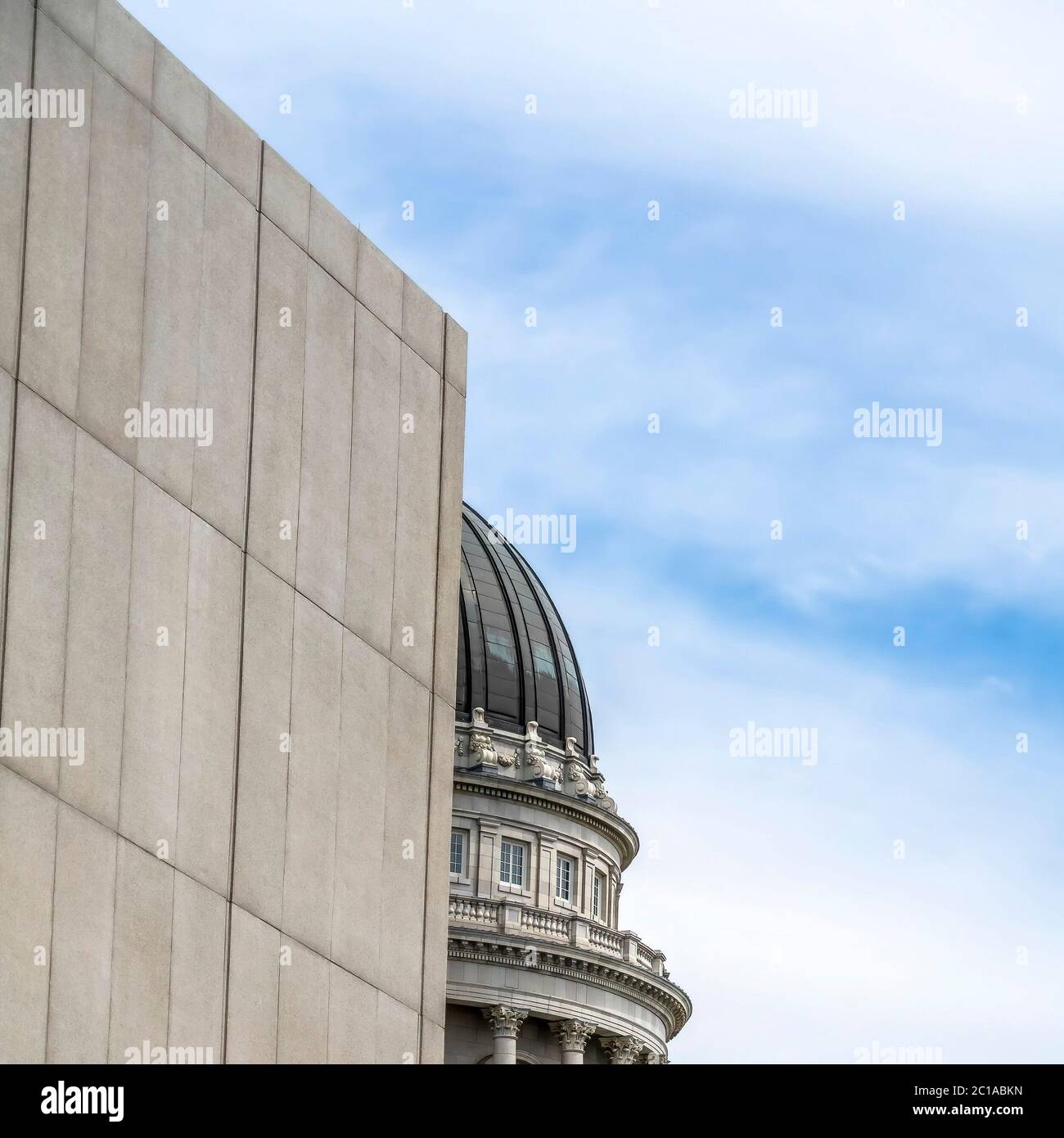Square frame Utah State Capital building and dome viewed behind a stone ...