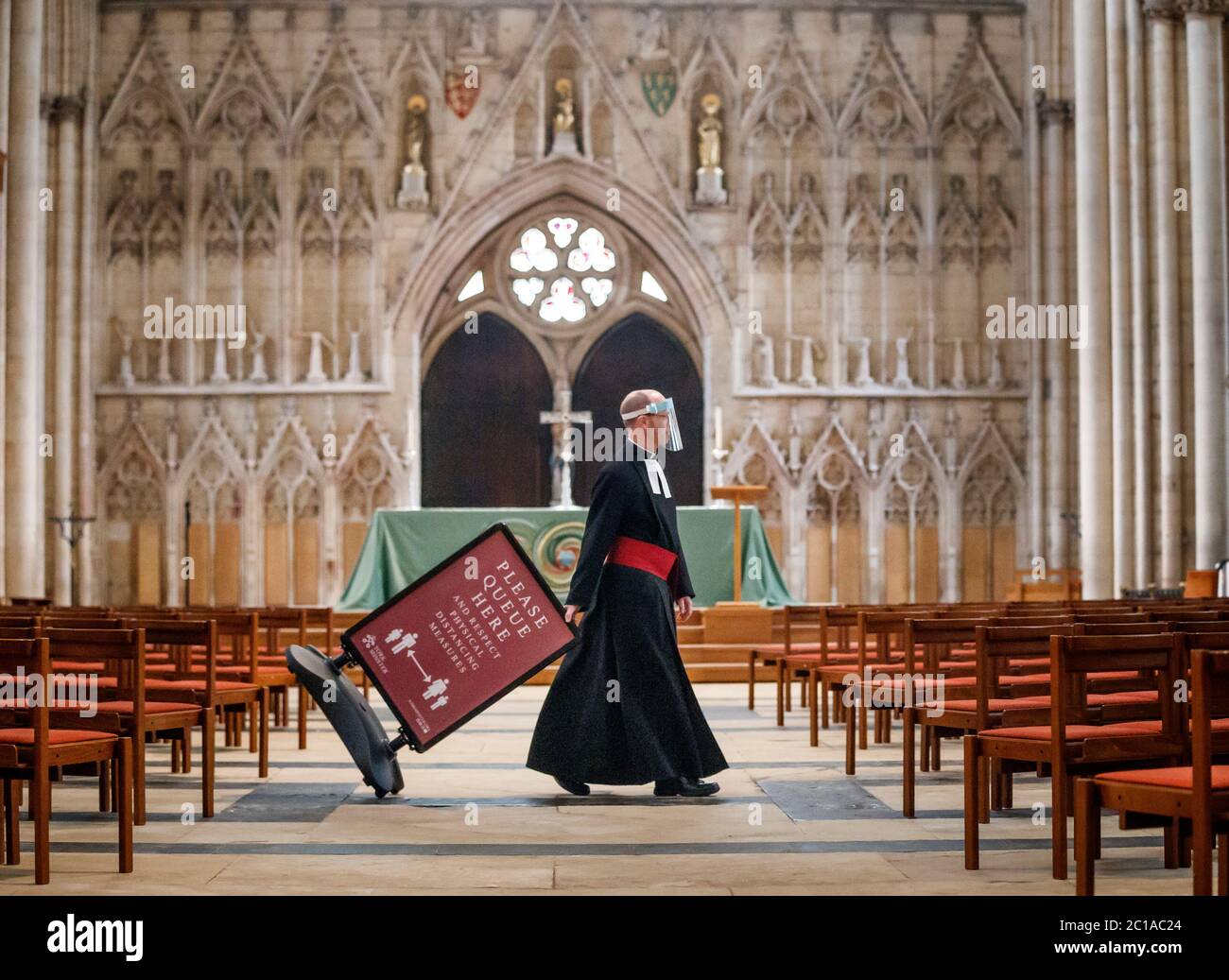 The Reverend Michael Smith, York Minster's Canon Pastor, moves a social ...