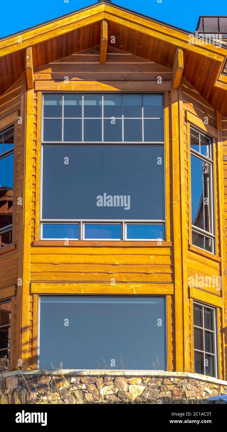 Vertical Multi storey home facade with large bay windows and wooden ...