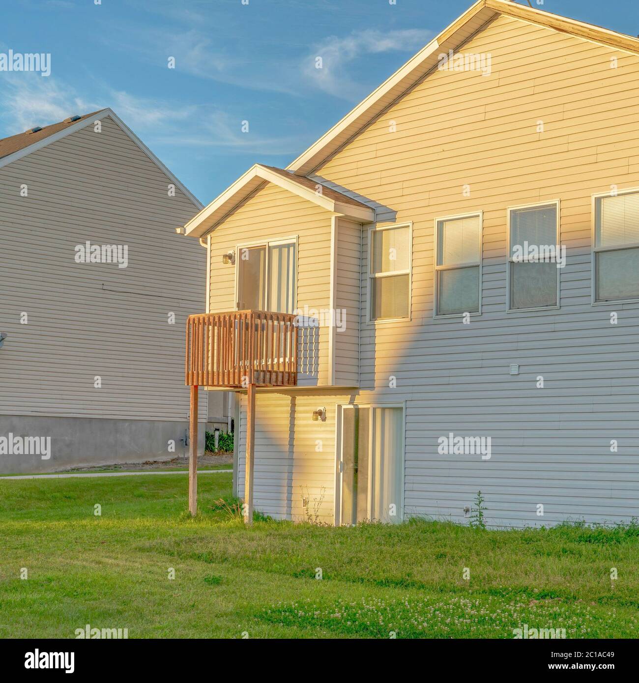 Square crop Home with white wall siding gable roof and small balcony ...