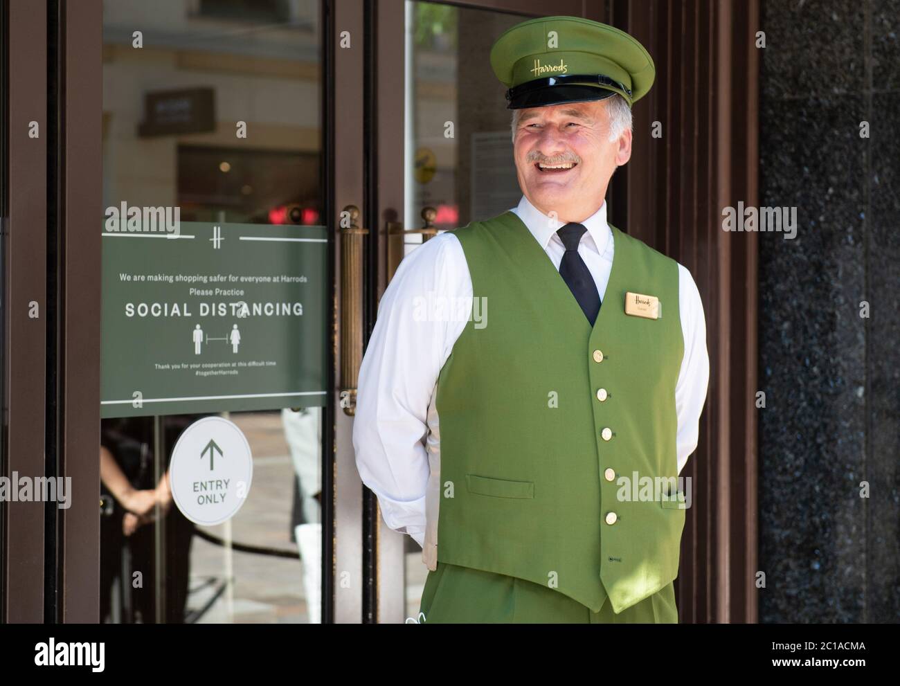 A Harrod's 'Green Man' welcomes customers back to Harrods store in ...