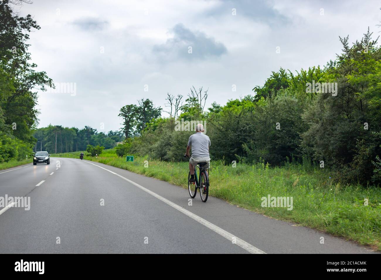Elderly man riding bicycle bike ride exercise park cycle hi-res stock ...
