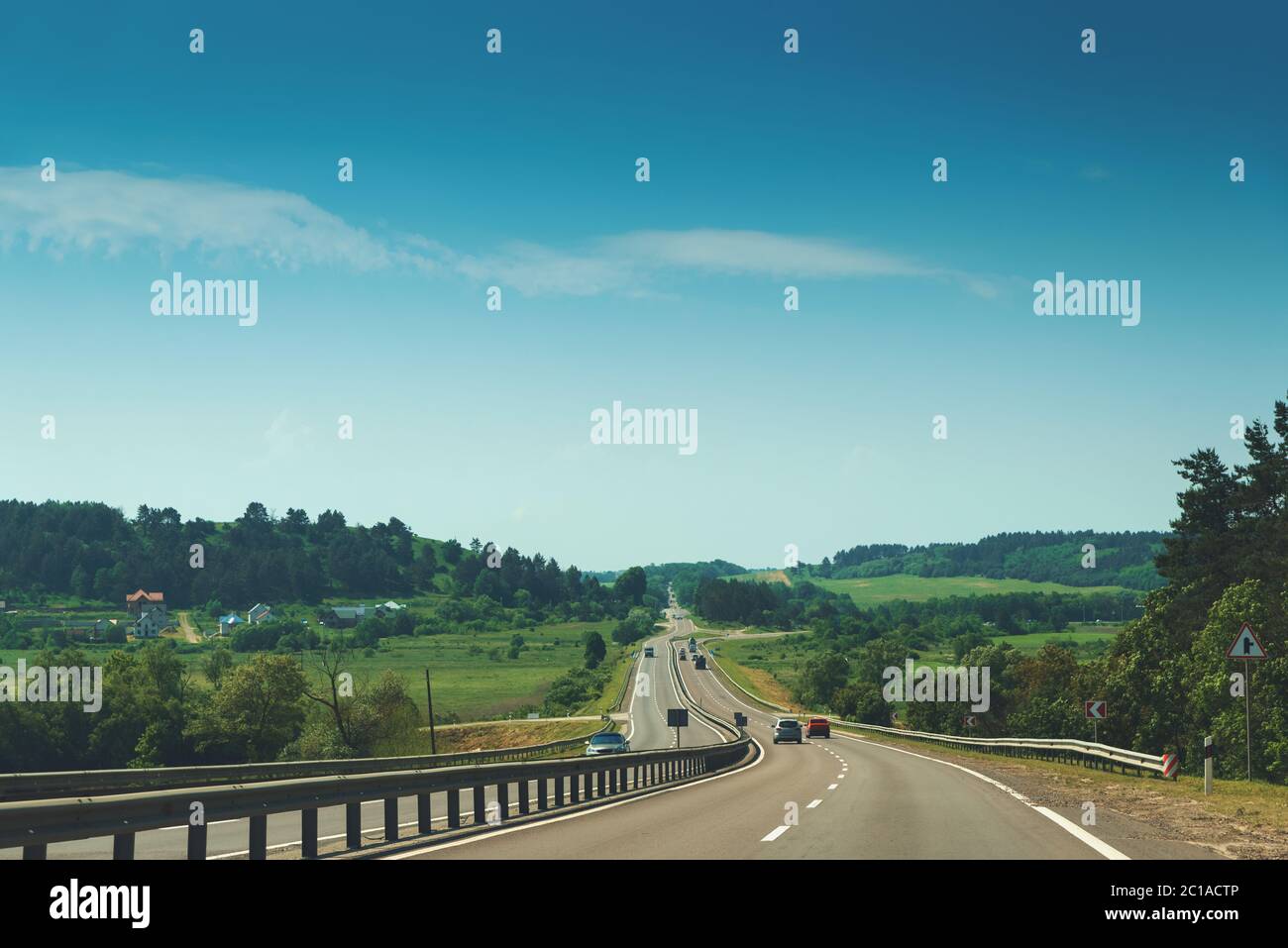 Traffic in high speed on a highway through summer landscape Stock Photo ...