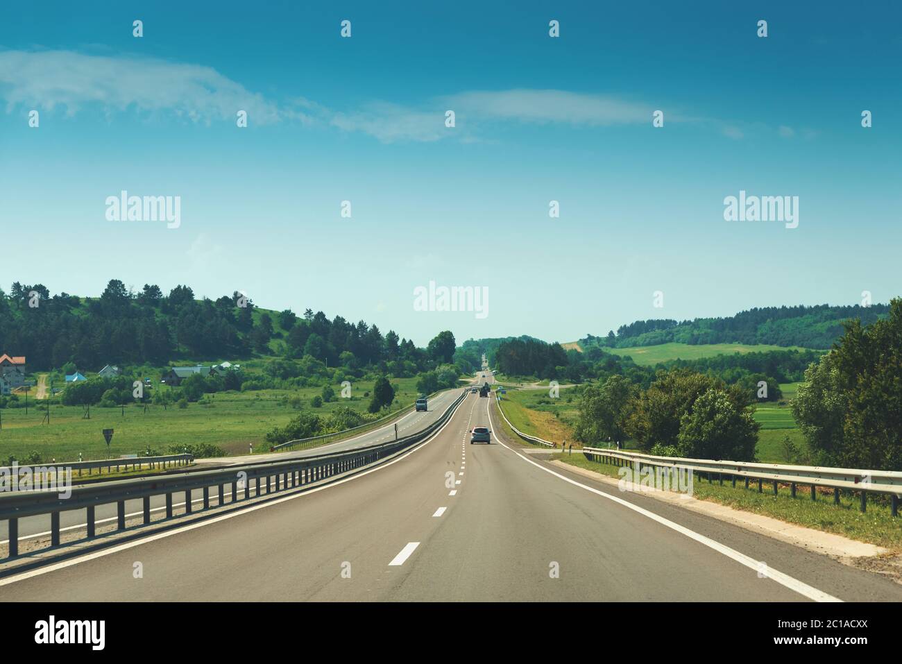 Traffic in high speed on a highway through summer landscape Stock Photo ...