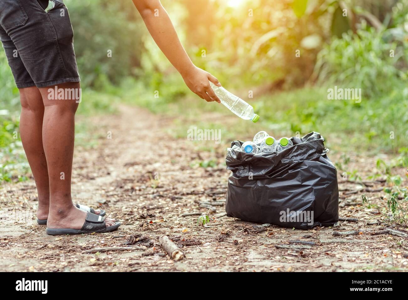 A man Keep garbage in the forest. Save the world concept Stock Photo ...