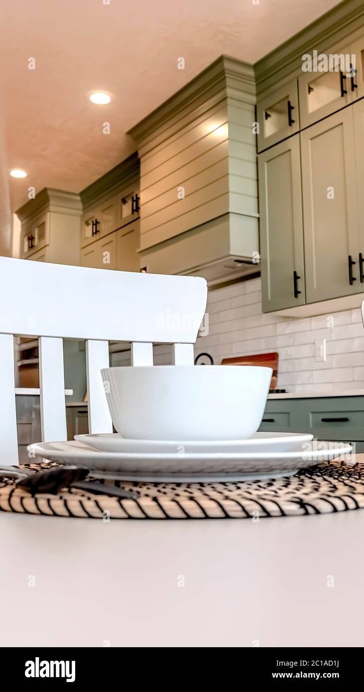 Vertical frame Tableware and utensils on dining table with view of ...