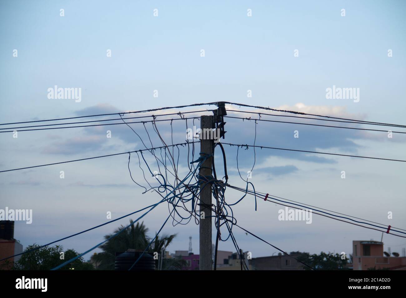 clutter Electric pole with wires background clouds Stock Photo - Alamy