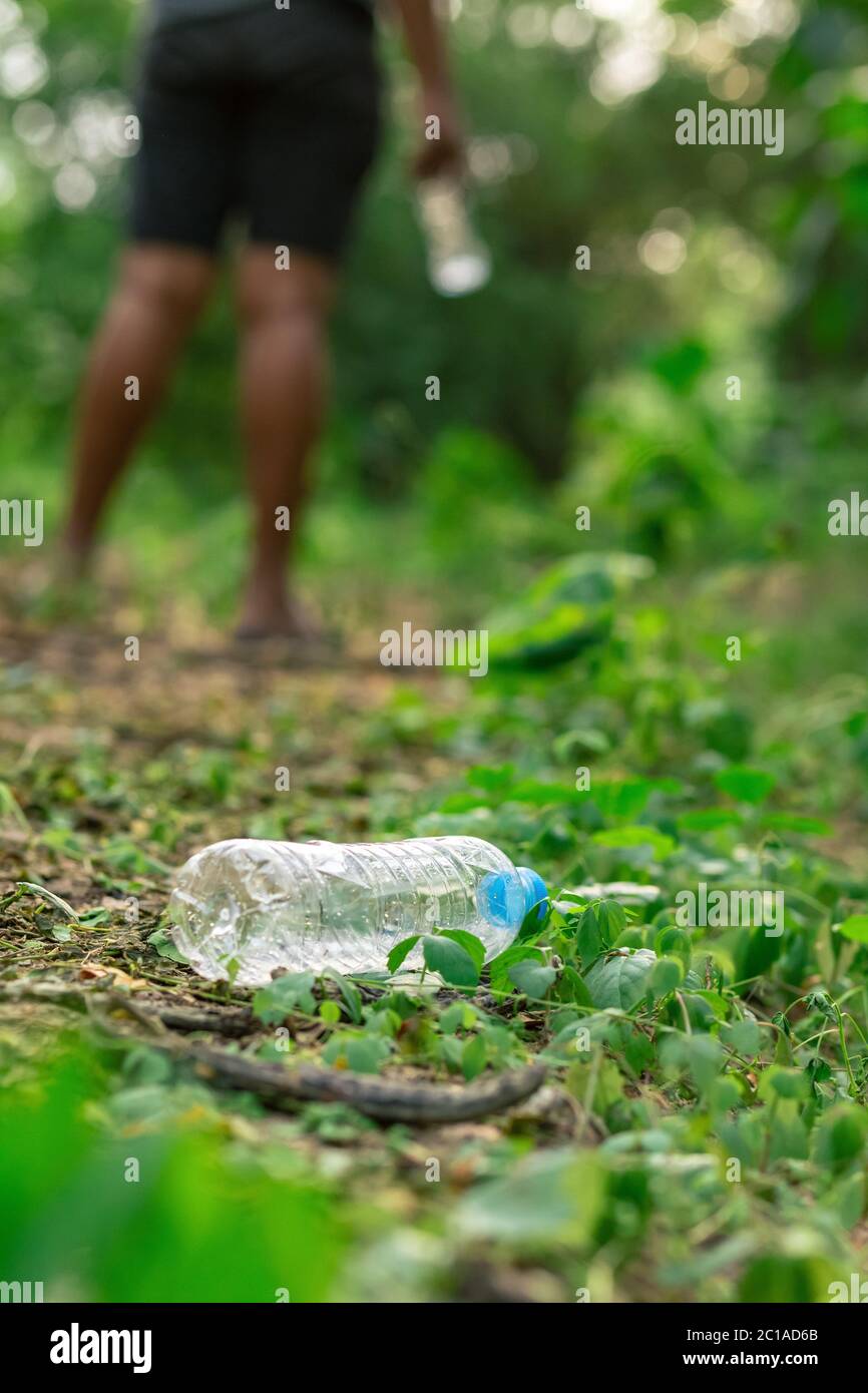 A man walking and throw garbage at forest Stock Photo - Alamy