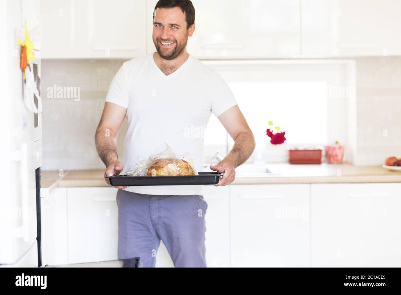 Portrait of a handsome man cooking at home in kitchen Stock Photo - Alamy