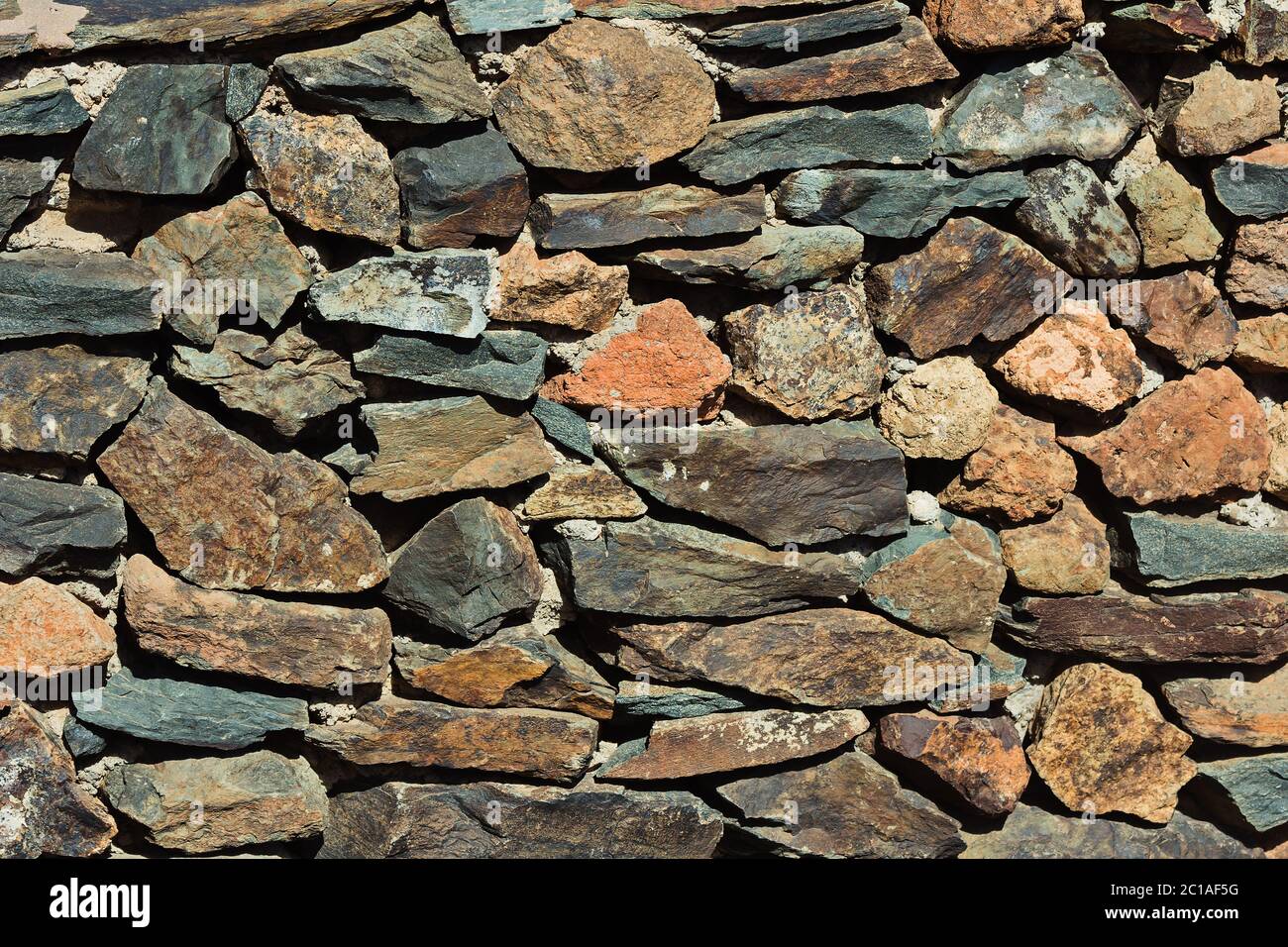 Stone wall made of natural stones - background Stock Photo - Alamy