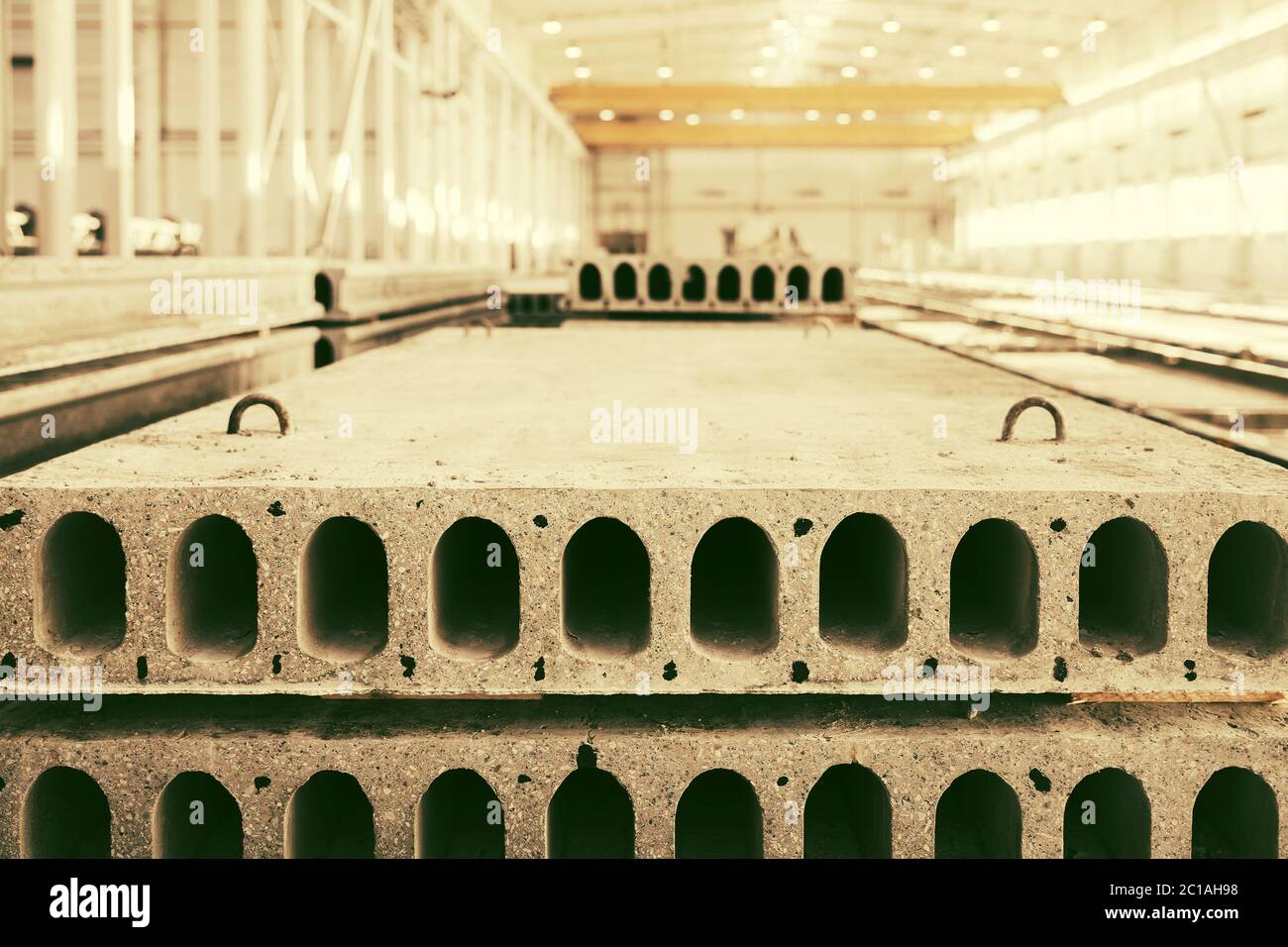 Stack of precast reinforced concrete slabs in a house-building factory ...