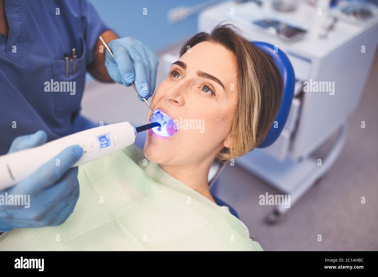Dentist curing tooth in dental hi-res stock photography and images - Alamy