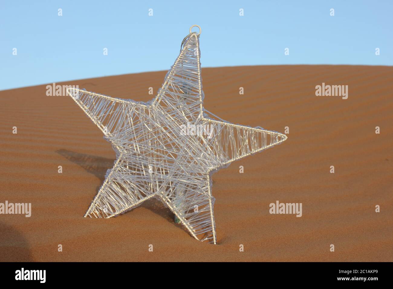 White star in brown desert sand dune. Concept for Christmas/Happy ...