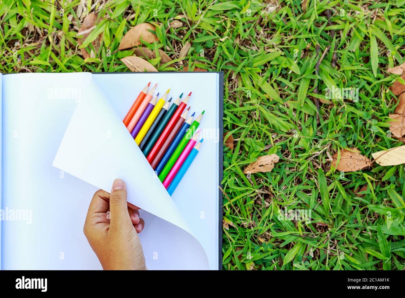 hand open white paper draw and crayon are on the paper.The white paper ...