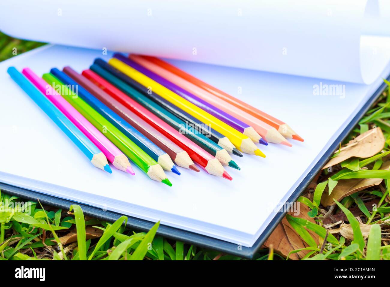 hand open white paper draw and crayon are on the paper.The white paper ...
