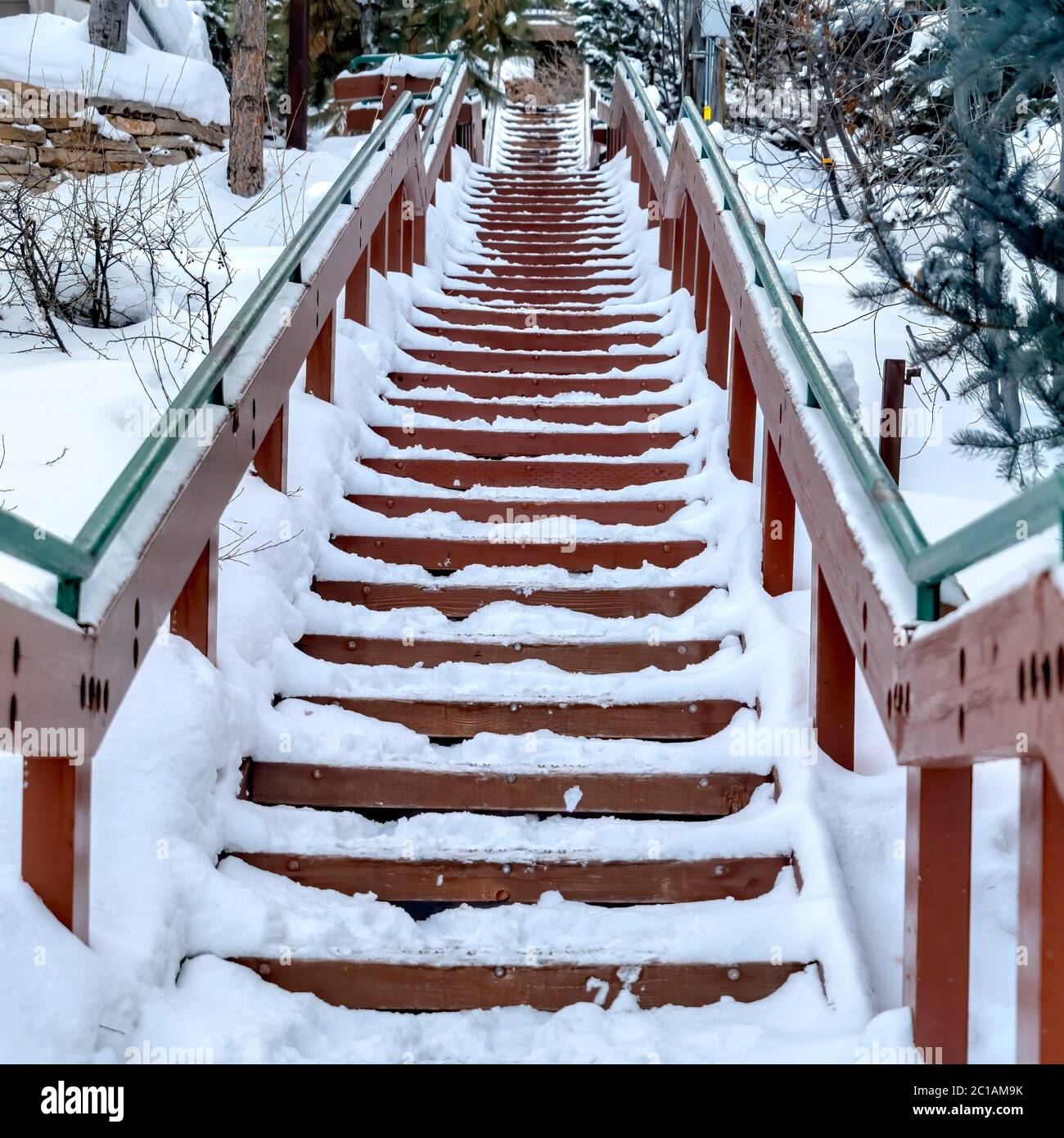 Square frame Focus on stairway that goes up a snowy hill with ...