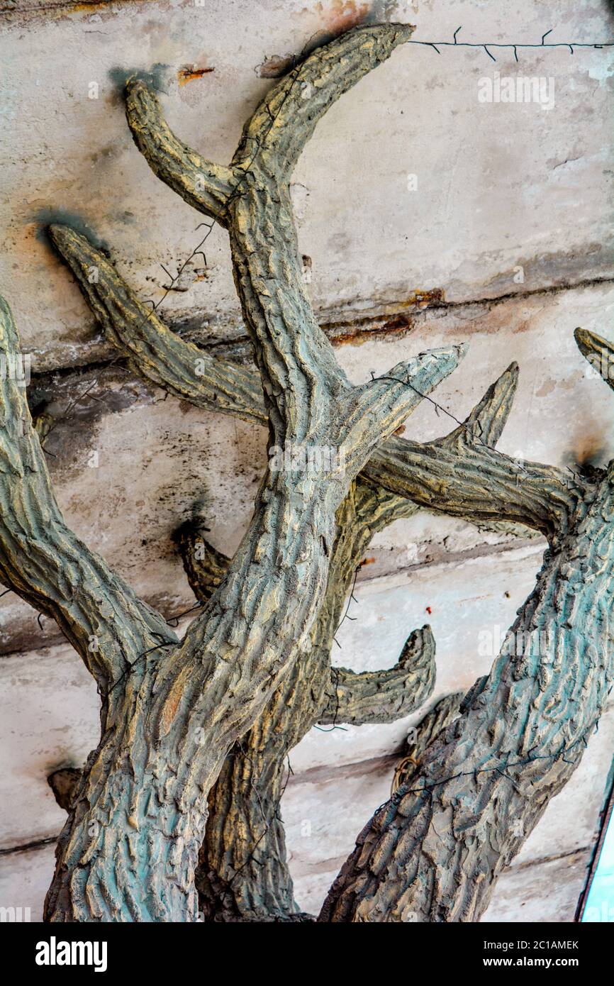 Clumsy artificial tree supports roof like decorative pillar ...