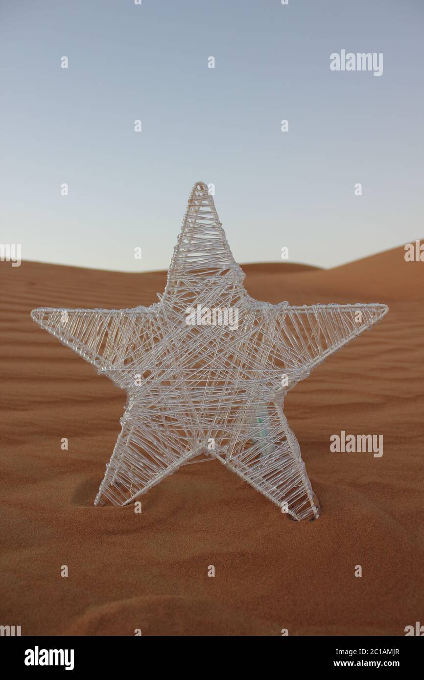 White star in brown desert sand dune. Concept for Christmas/Happy ...