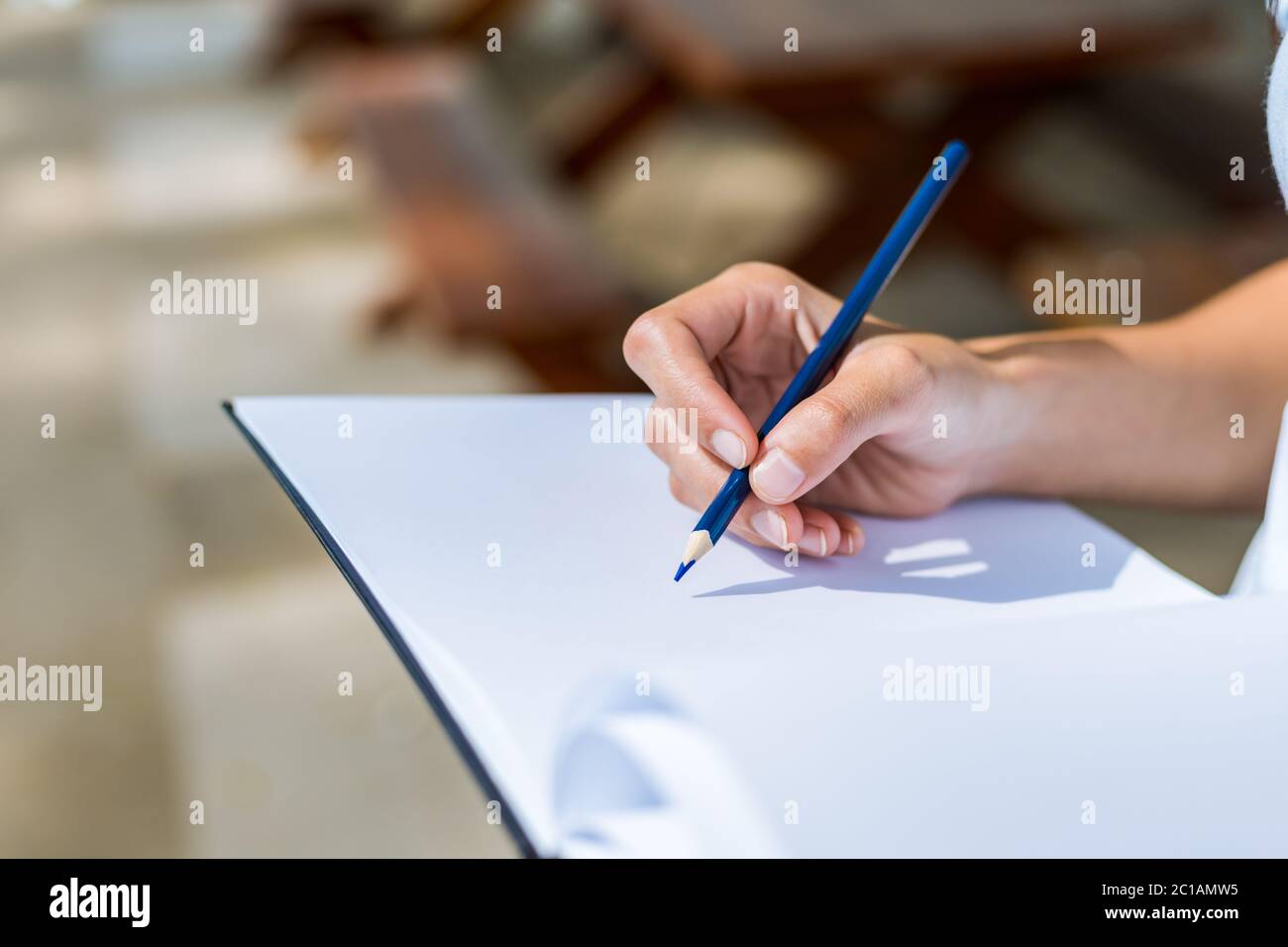 hand use crayon for drawing paper in the parks Stock Photo - Alamy