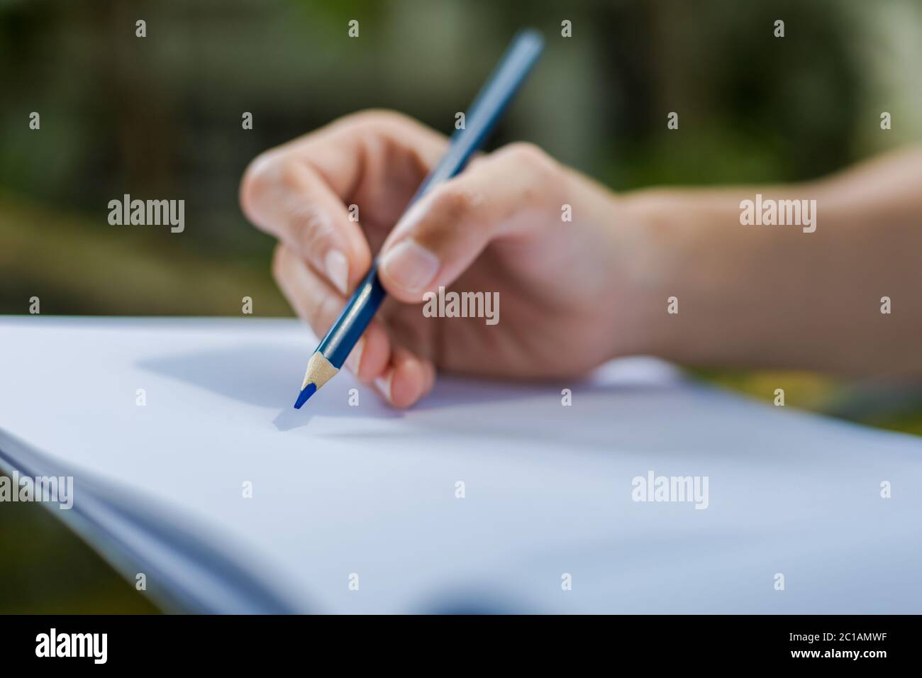 hand use crayon for drawing paper in the parks Stock Photo - Alamy