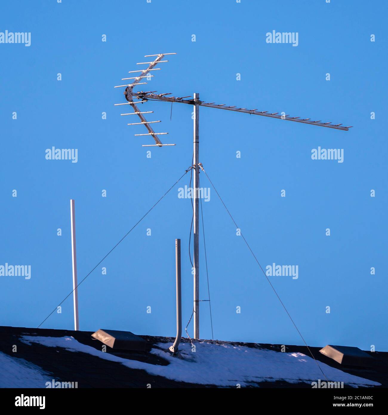 Square frame Communications antenna mounted on a rooftop day light ...