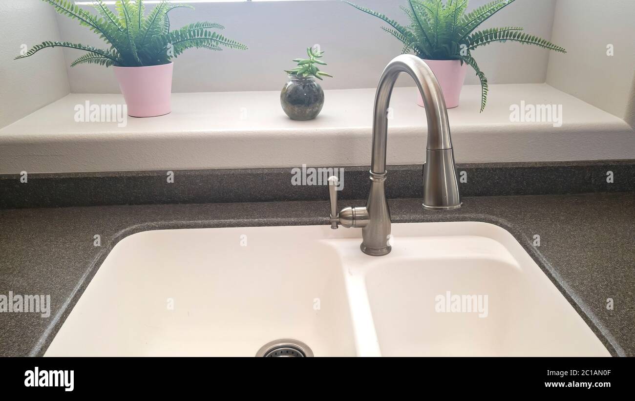 Panorama frame Sink with double bowl and stainless steel faucet against ...