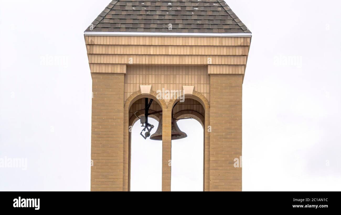 Panorama crop Modern belfry tower of a religious building with roof and ...