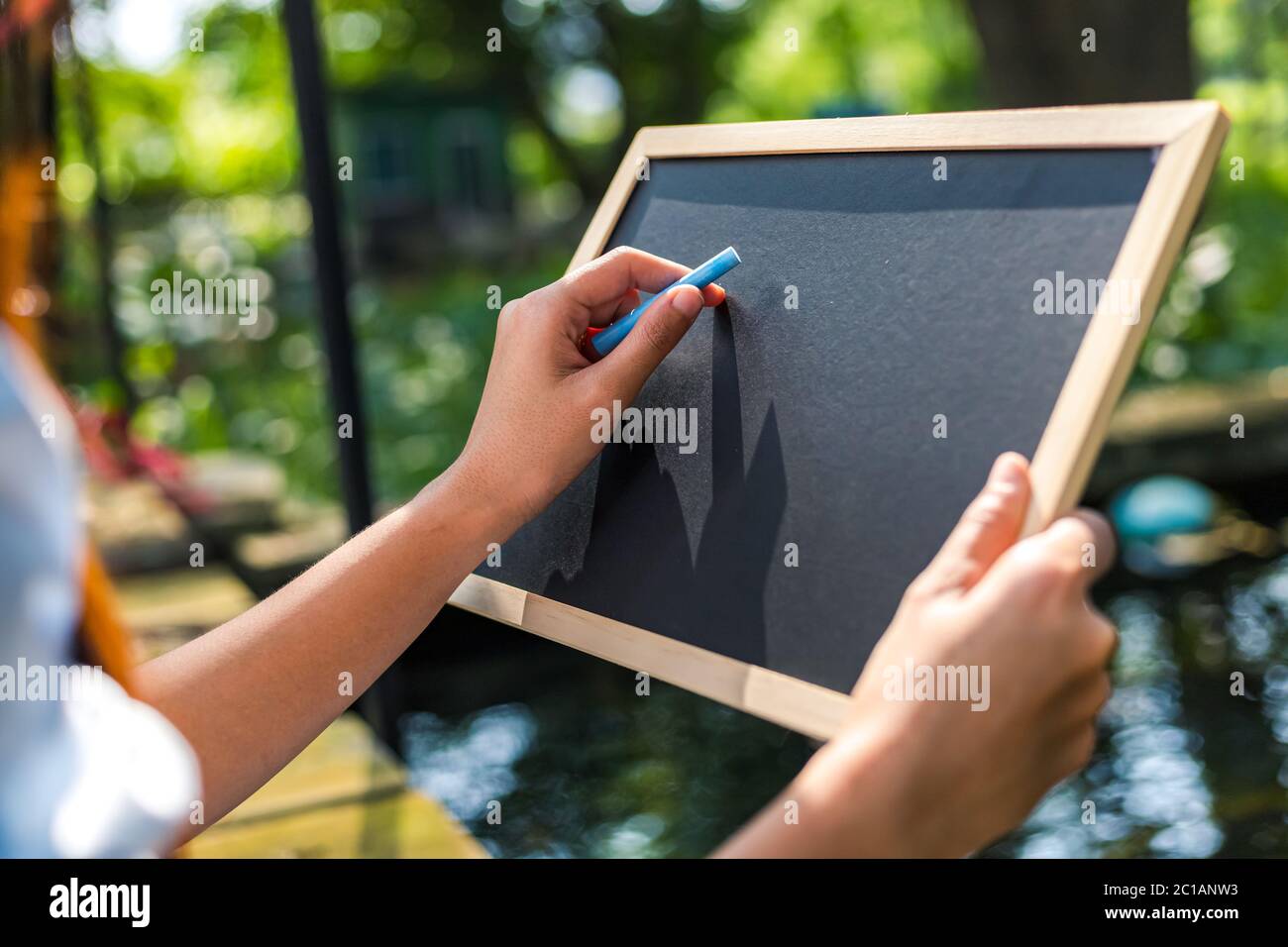 Hands use chalk for drawing, writing balckboard in the parks. Education ...