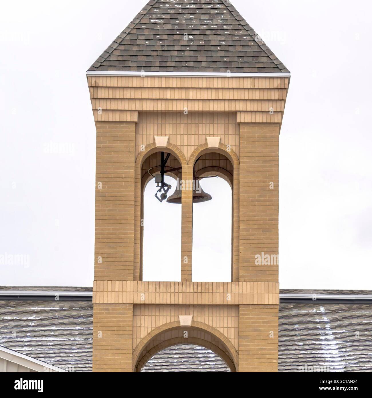 Square Modern belfry tower of a religious building with roof and cloudy ...